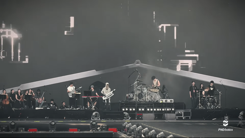 Watch China’s Rockstar Robot Perform Live At A Concert